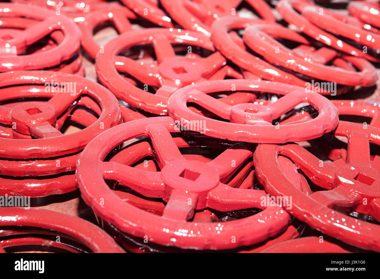 Red painted hand wheels for globe and gate valves are stored in a ...