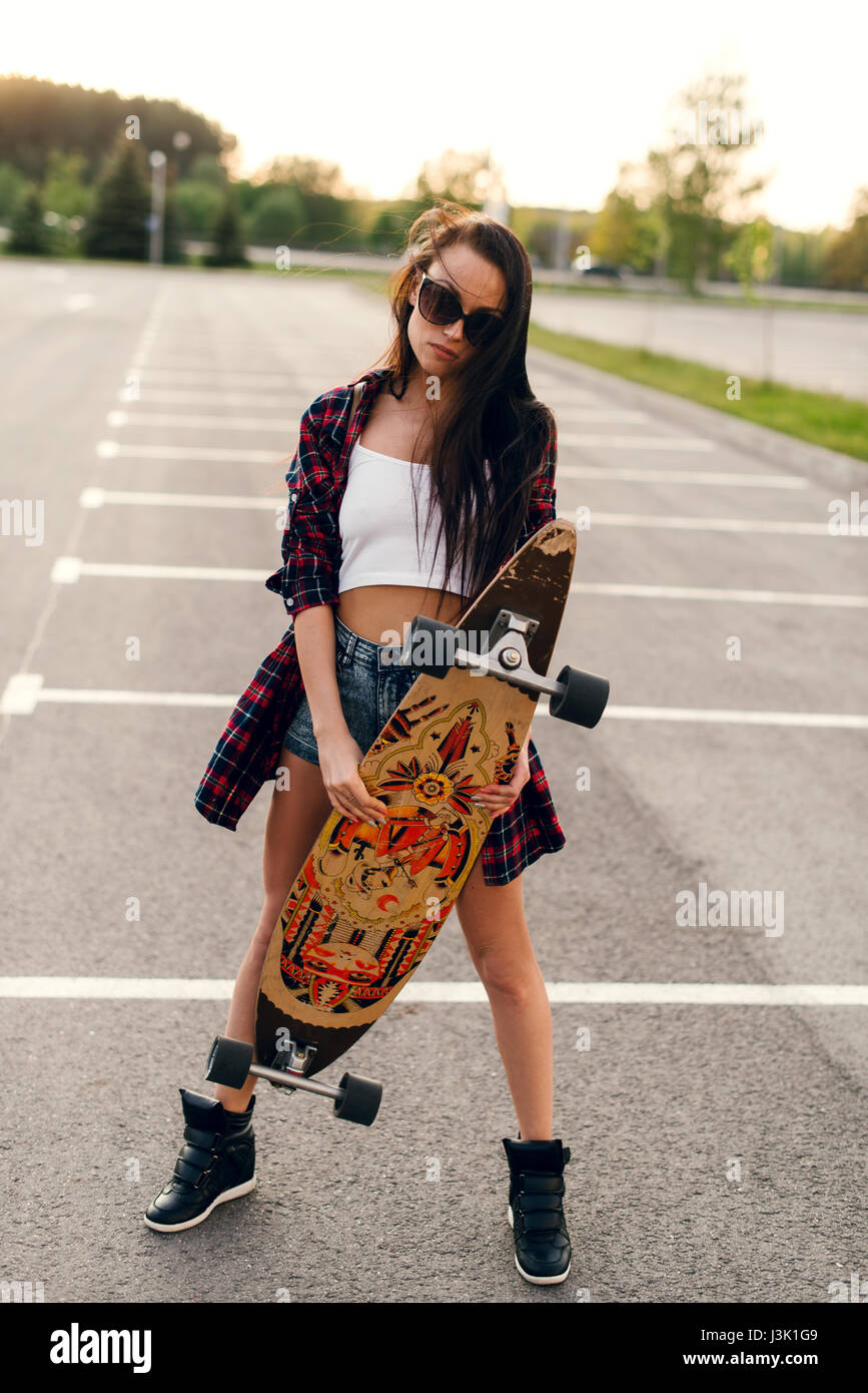 Sport fashion girl posing in summer with skateboard Stock Photo - Alamy