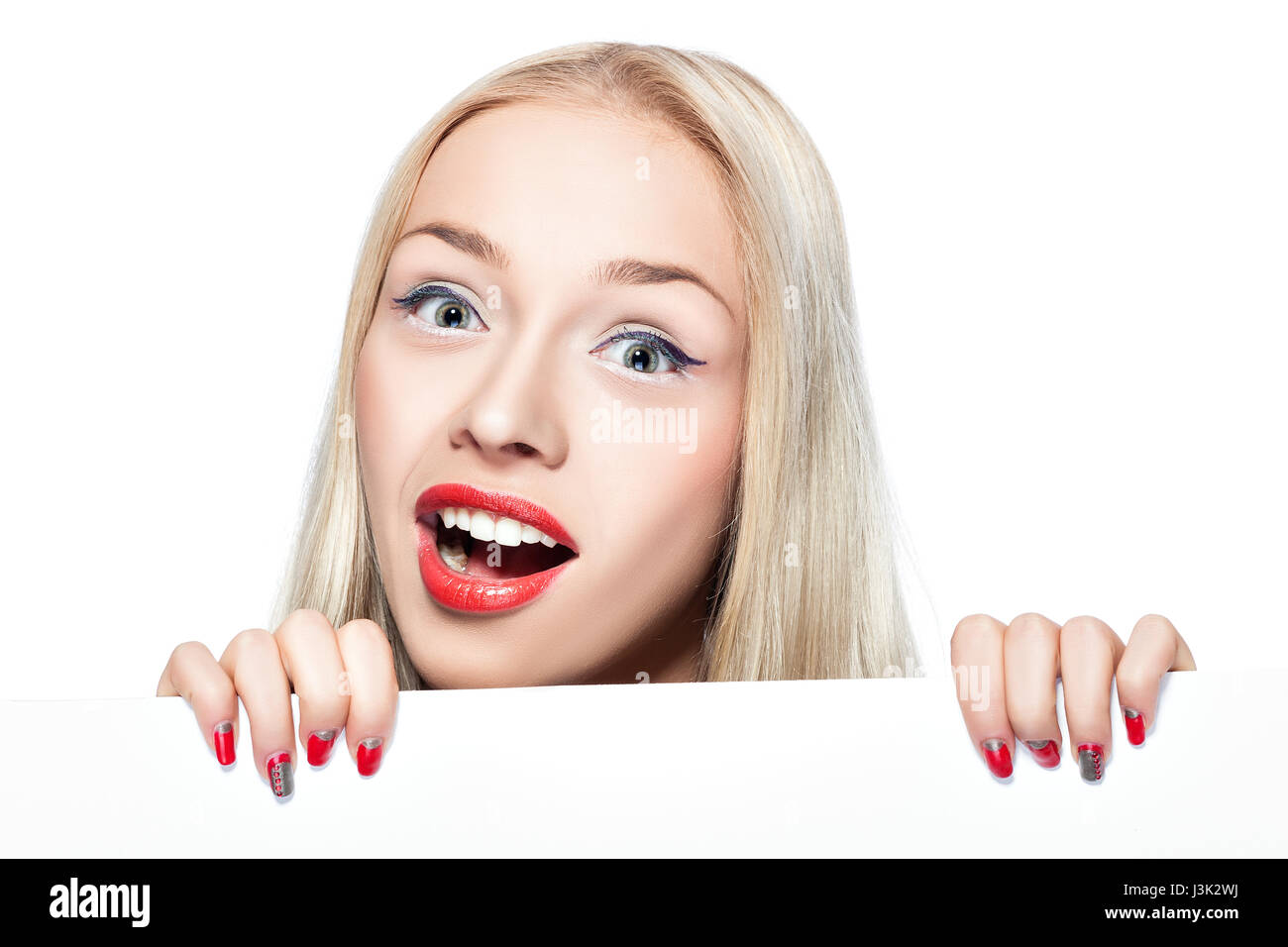 Blonde peeking out from behind a poster on which you can make ...