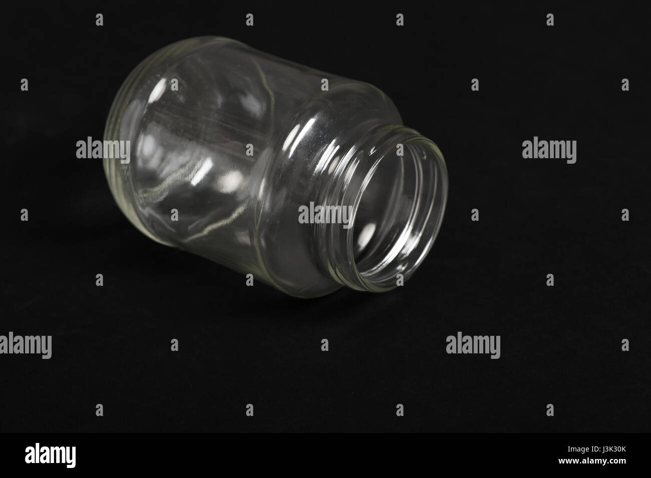 Empty glass jar on the back background Stock Photo - Alamy