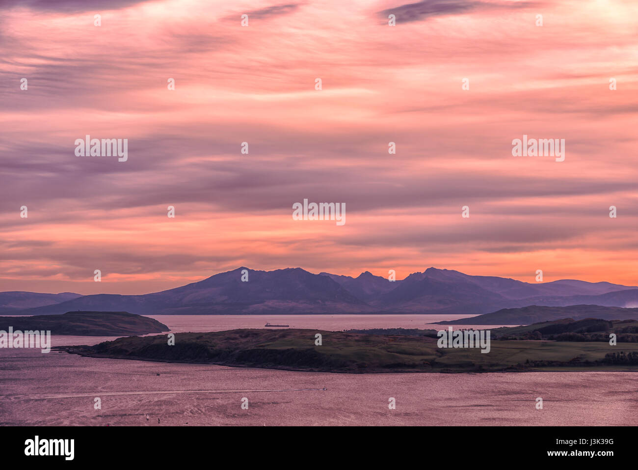 Arran Hills after the sun sets on the River Clyde with the Cumbrae's in ...