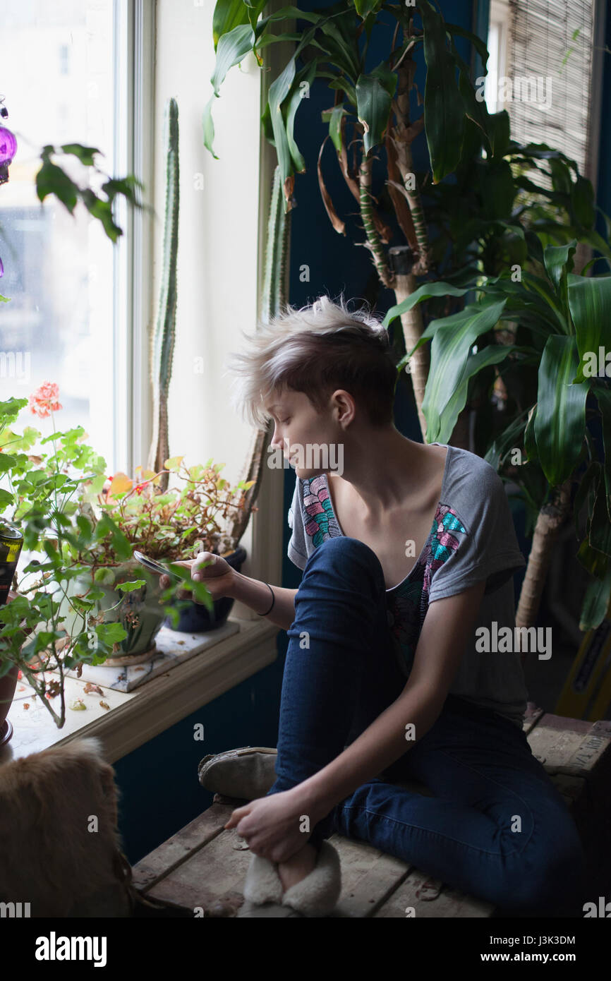 Young woman hanging out in her apartment Stock Photo - Alamy