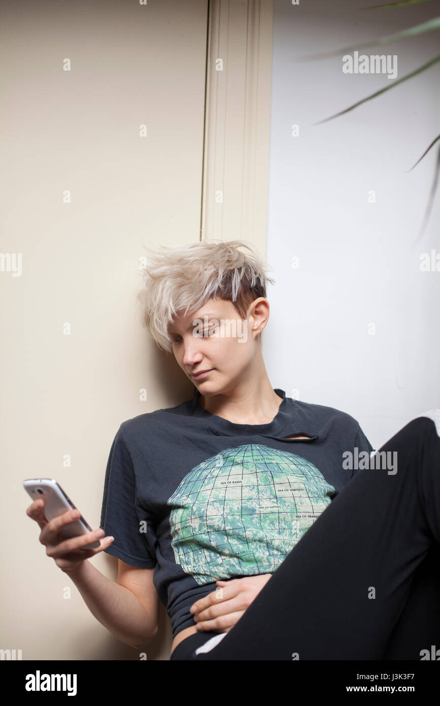 Young woman hanging out in her apartment Stock Photo - Alamy