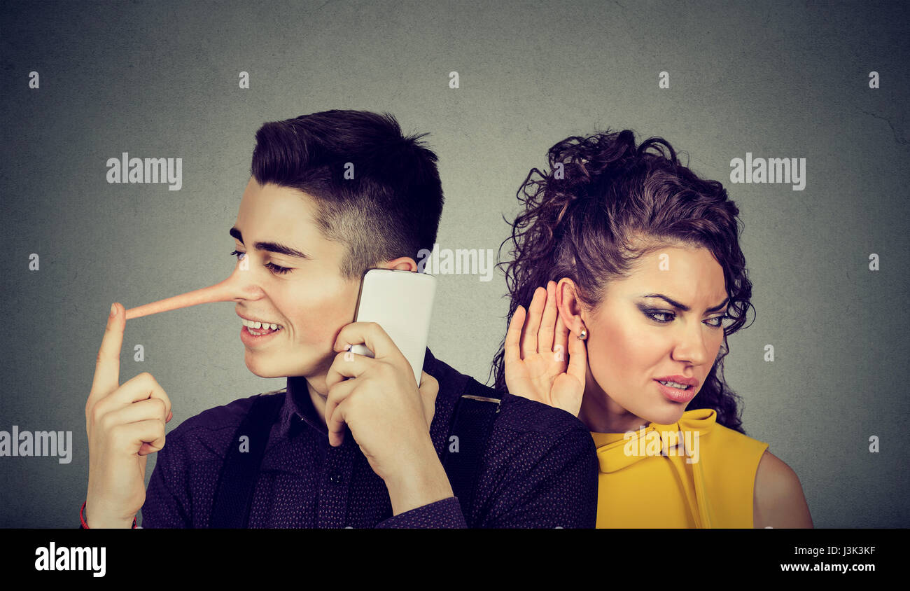 Curious worried woman secretly listening to a happy man liar talking on ...