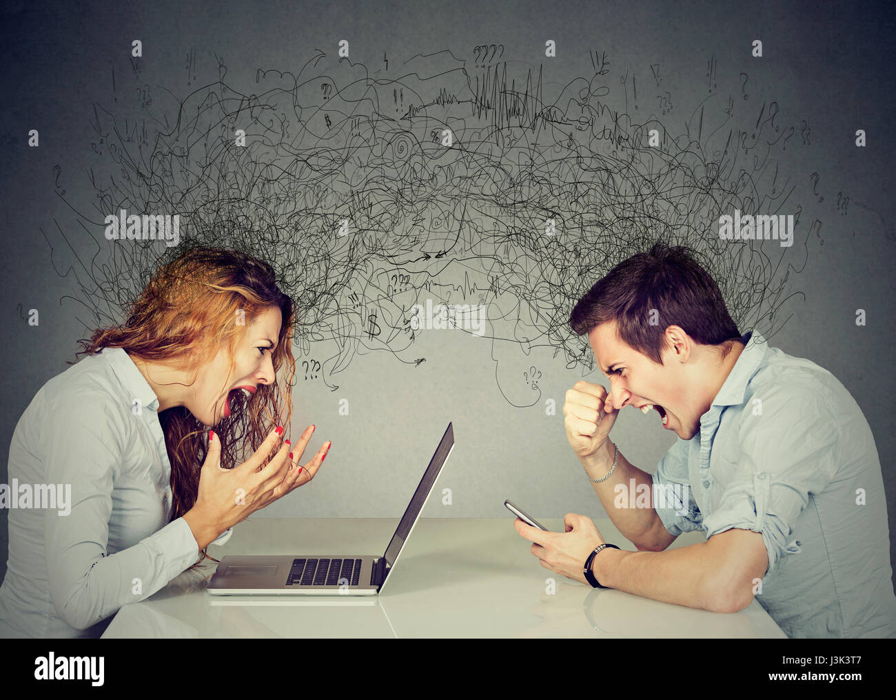 Stressed business woman screaming at laptop sitting at table across ...