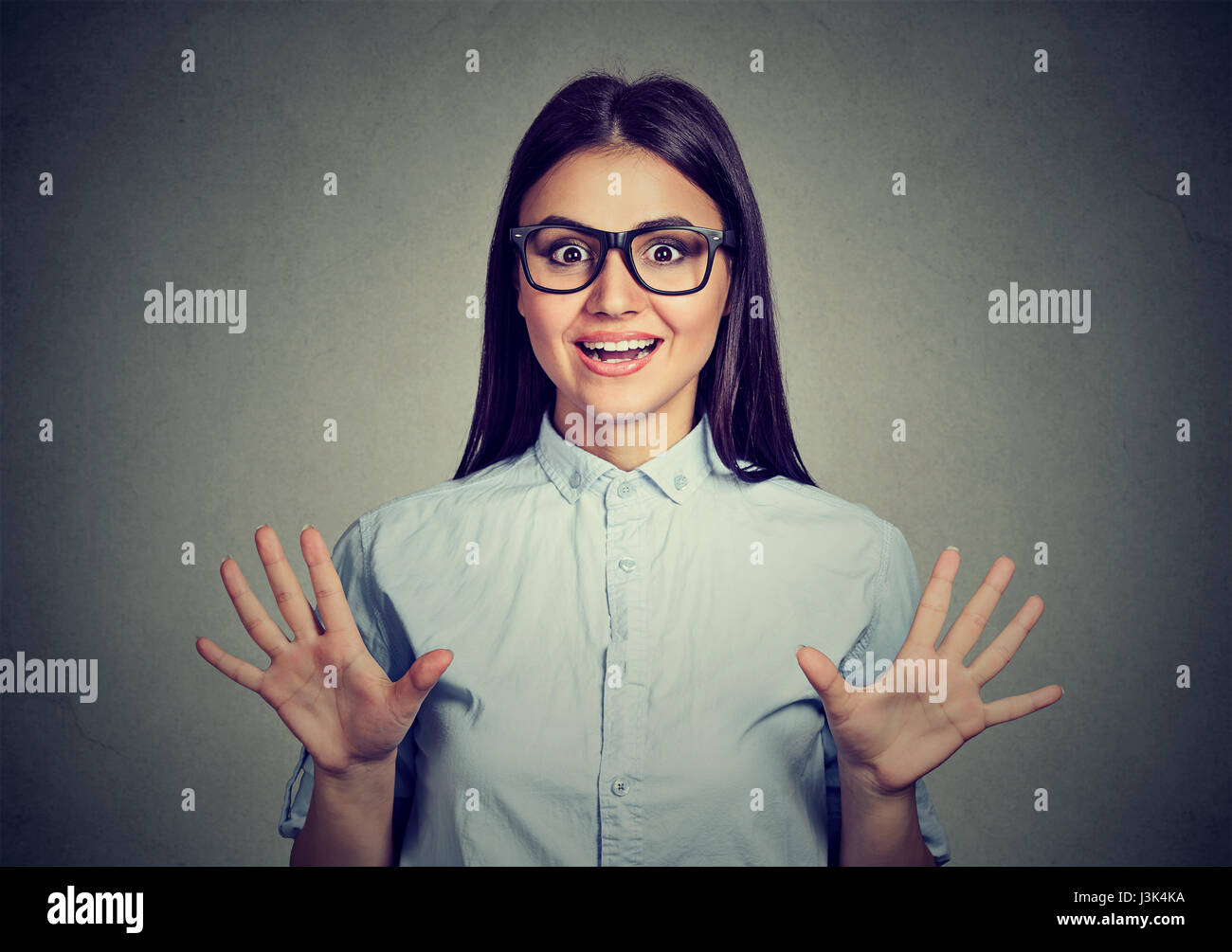 Surprised young woman shouting isolated on gray background. Looking at ...