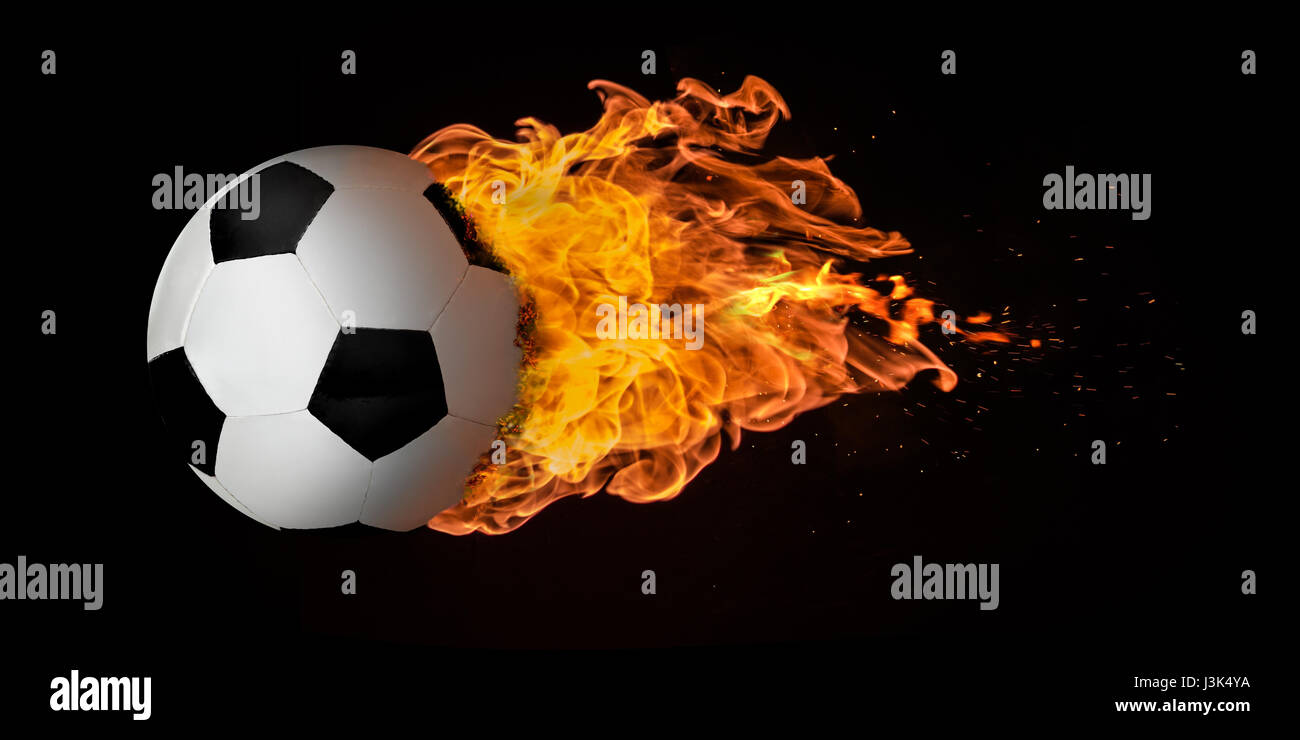 Flying football or soccer ball engulfed in trailing flames with sparks ...