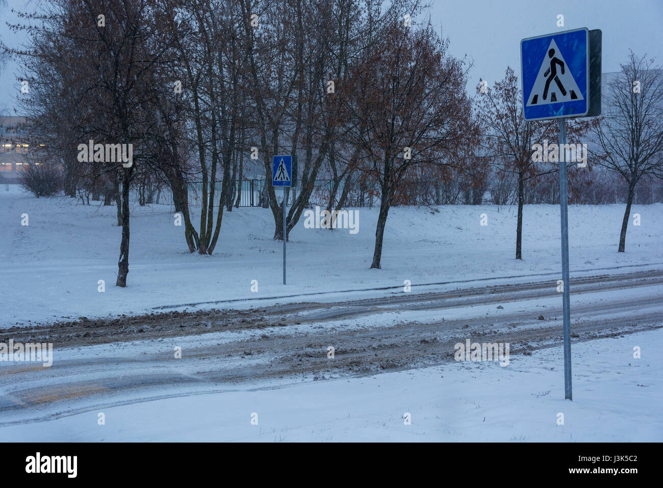 Pedestrian crossing through the snowy road Stock Photo - Alamy