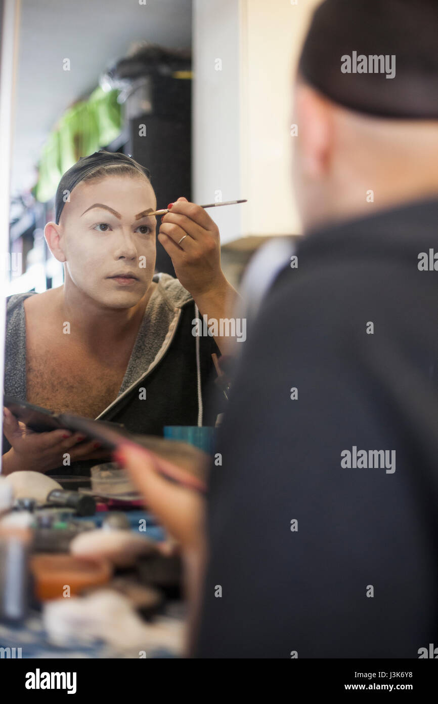 Young man applying drag makeup Stock Photo - Alamy