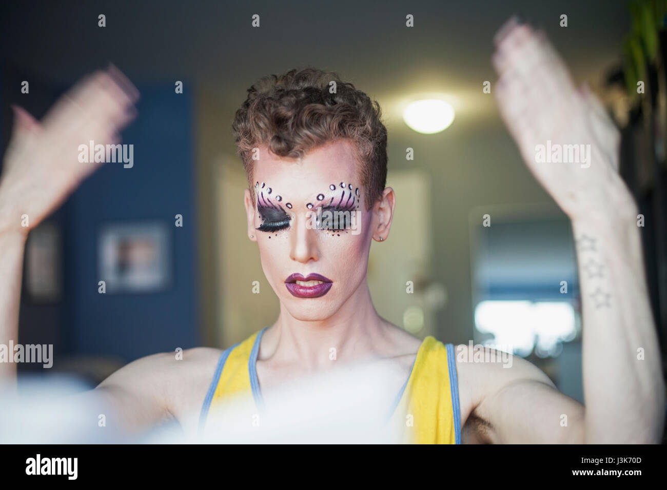 Young man applying drag makeup Stock Photo - Alamy