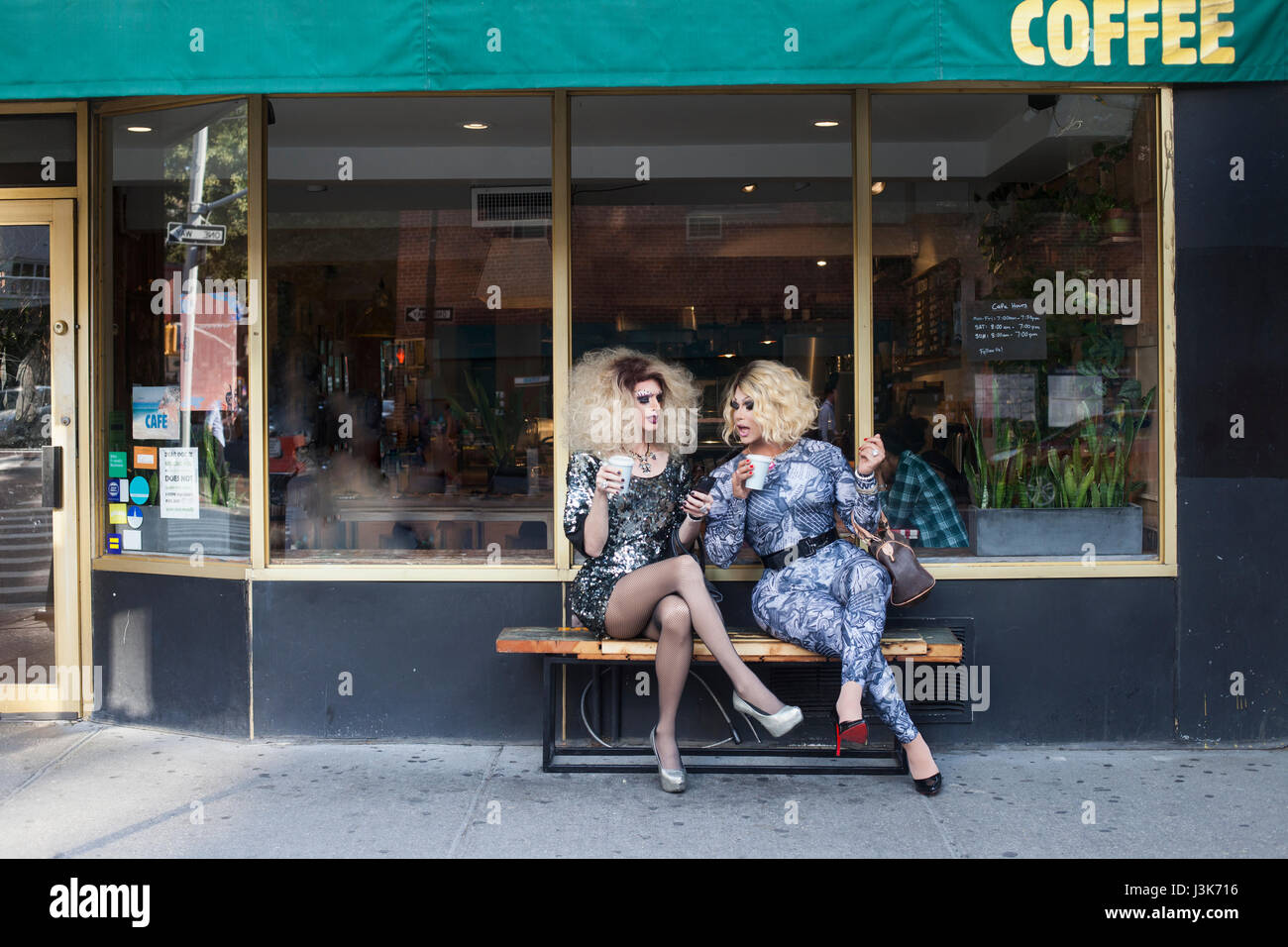 Two drag queens sitting drinking coffee Stock Photo - Alamy
