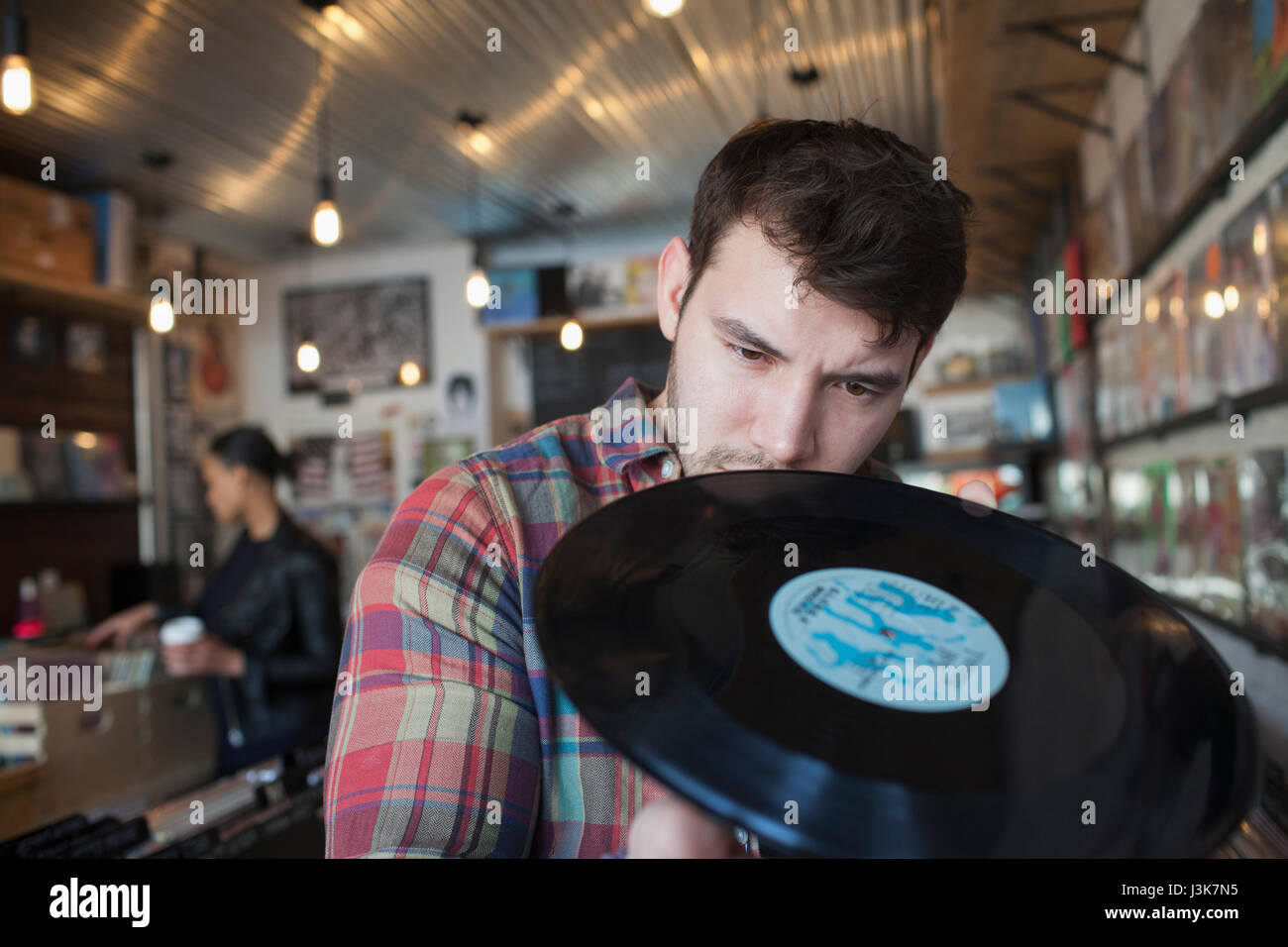Young man and woman in a record store Stock Photo - Alamy