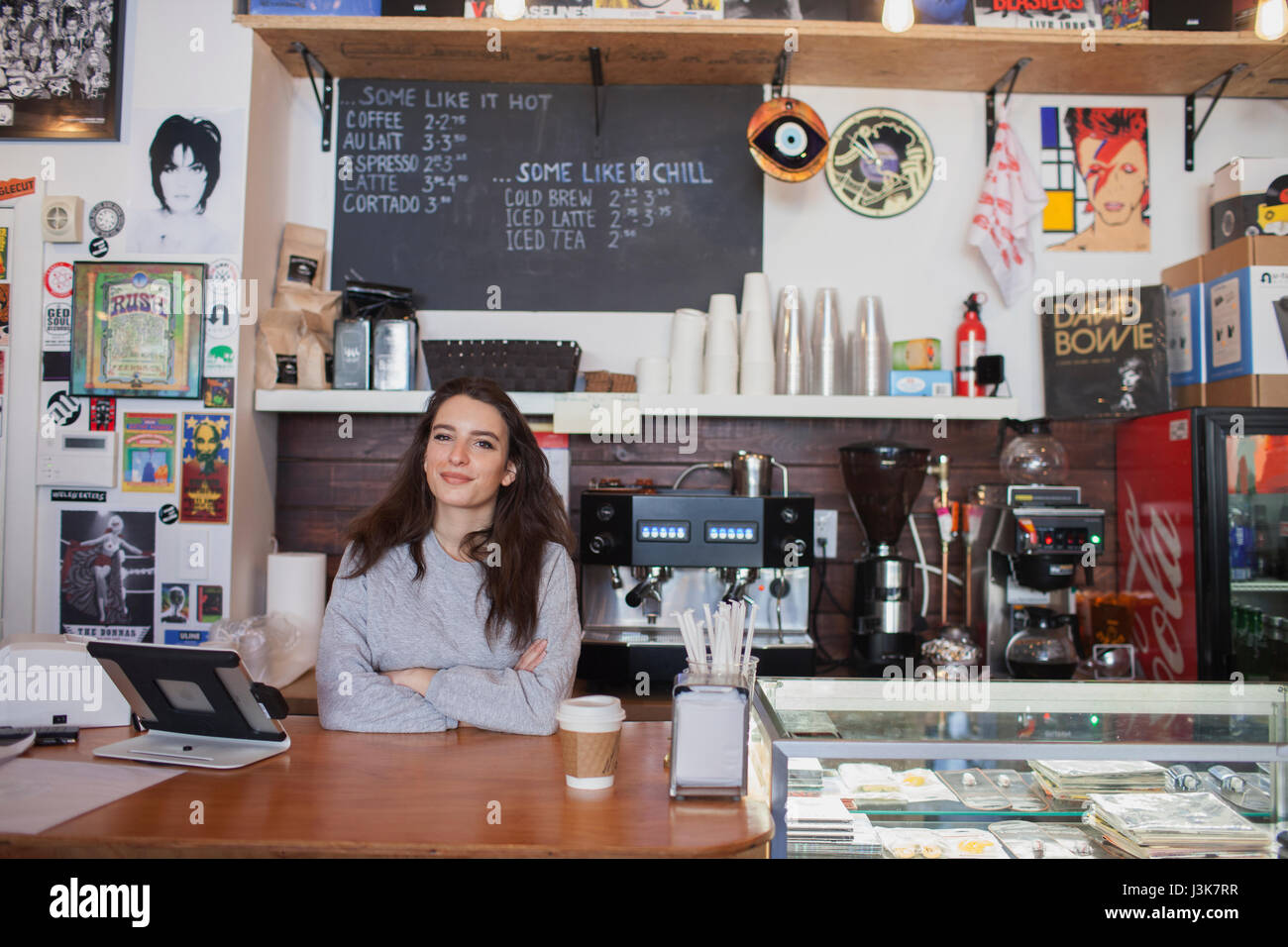 Young woman at store counter Stock Photo - Alamy