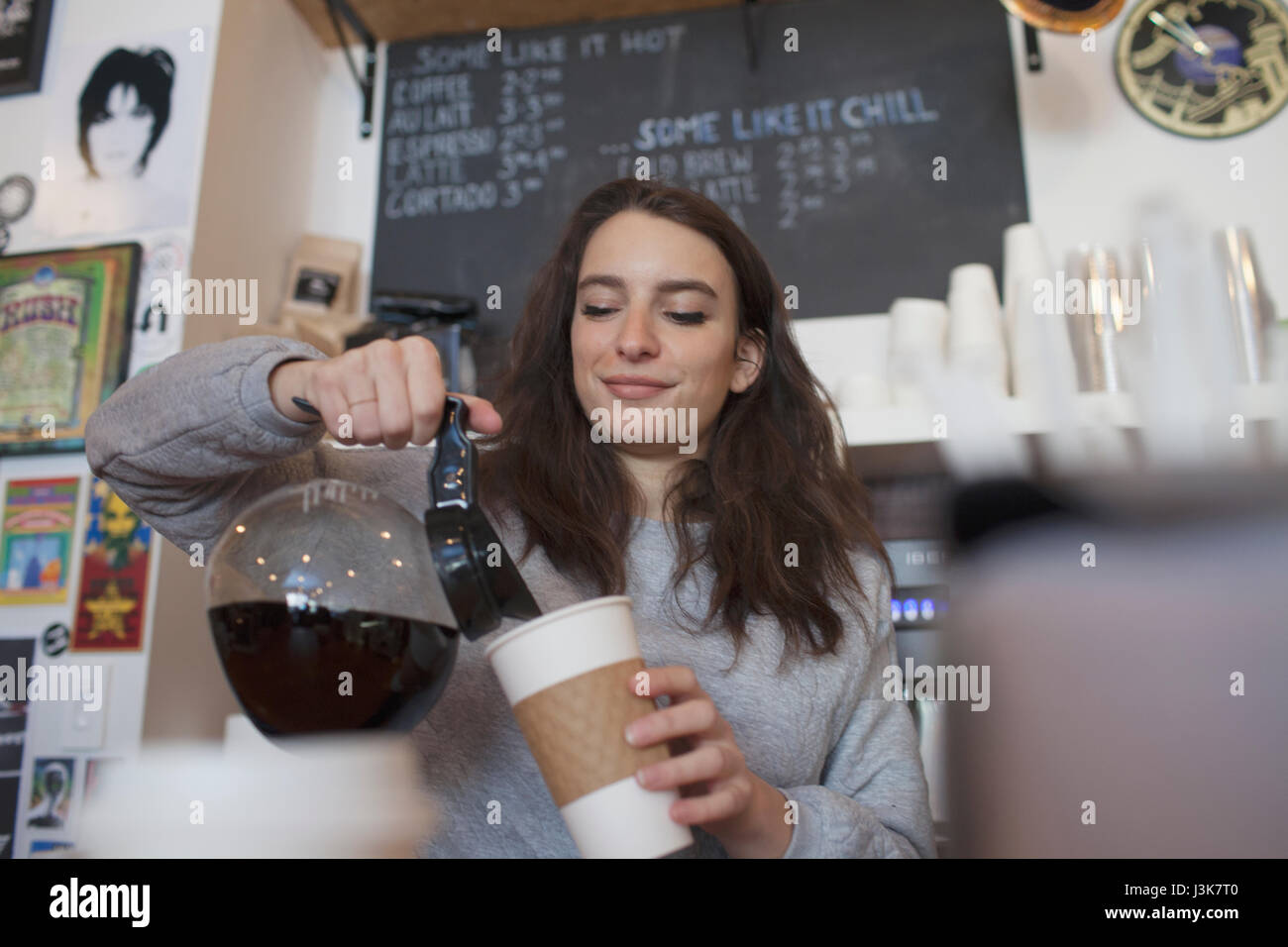 Young woman at store counter Stock Photo - Alamy