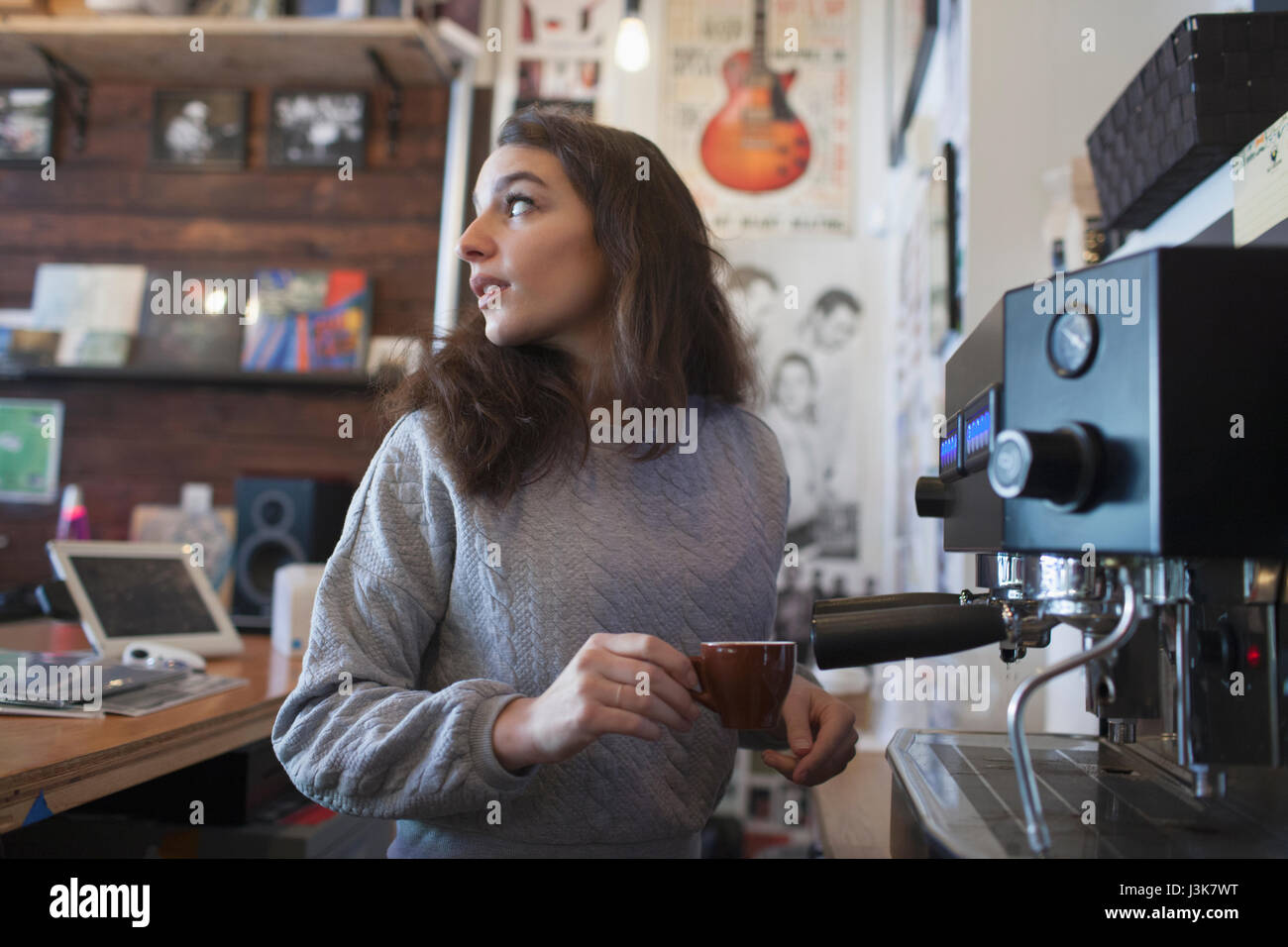 Young woman at store counter Stock Photo - Alamy