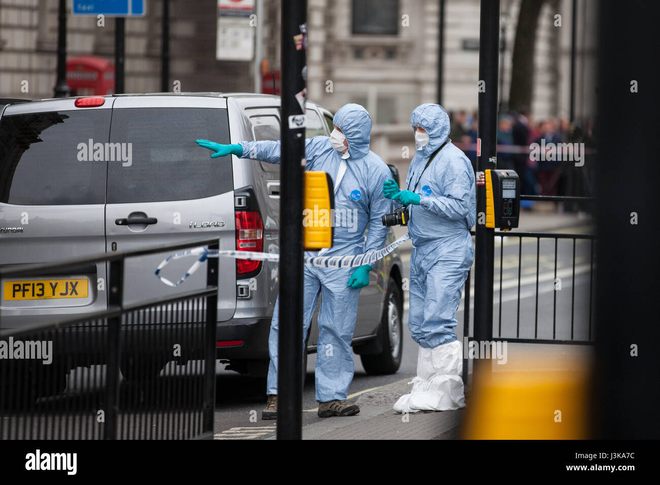 As police officers carry out their investigation hi-res stock ...