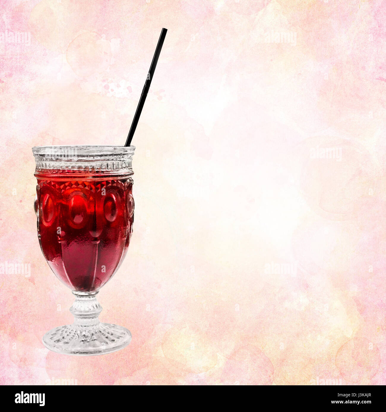 A photo of a vibrant red cocktail with a straw on a pink watercolor ...