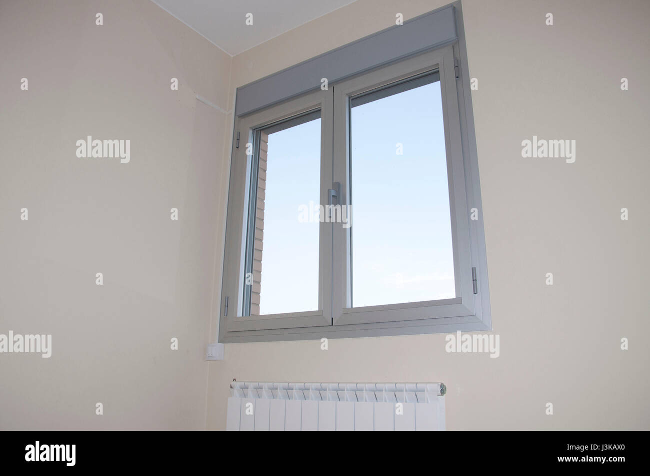 Aluminum window installed over a radiator Stock Photo - Alamy
