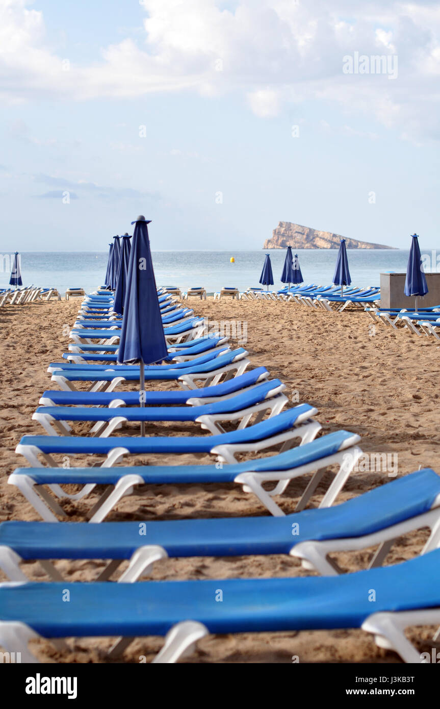 Empty beach only with its blue sunbeds Stock Photo - Alamy