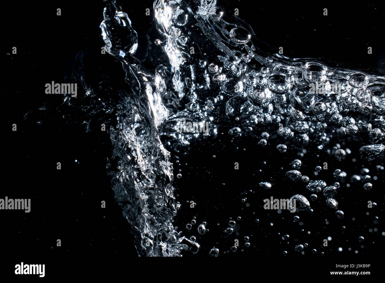 Bubbles, stream and splashes in aquarium on black background Stock ...