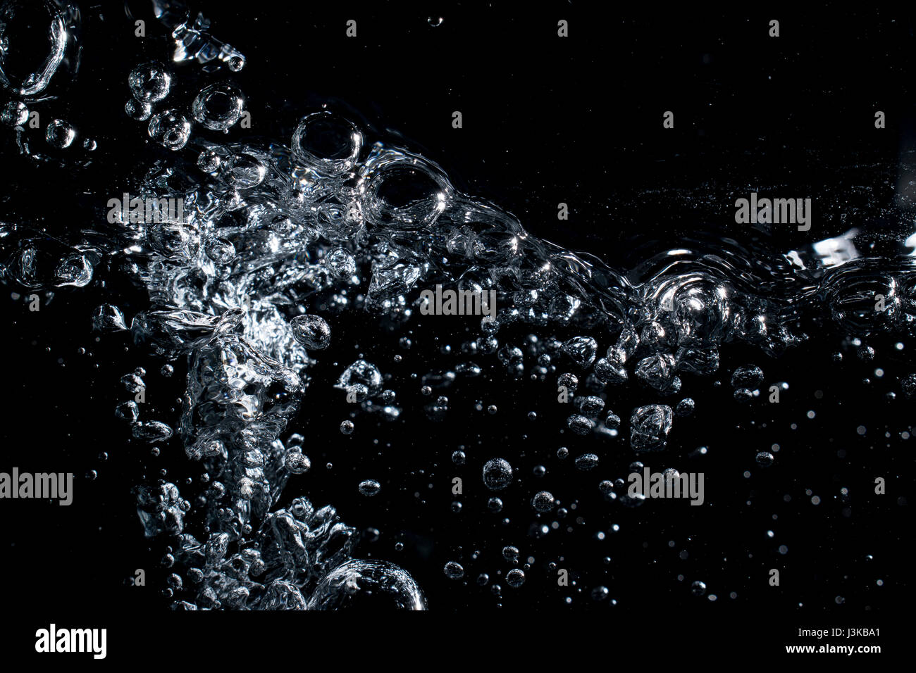 Bubbles, stream and splashes in aquarium on black background Stock ...