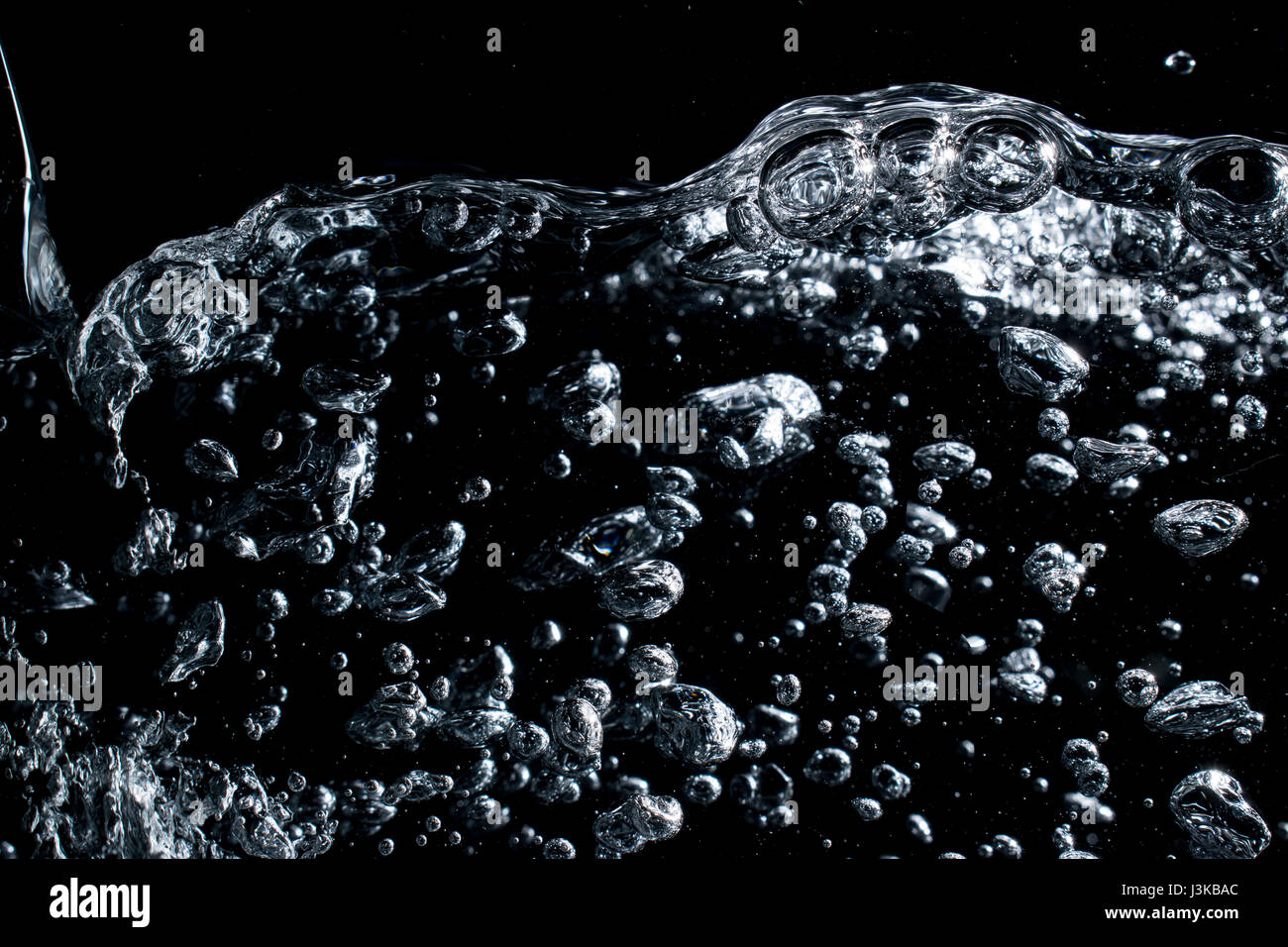 Bubbles, stream and splashes in aquarium on black background Stock ...