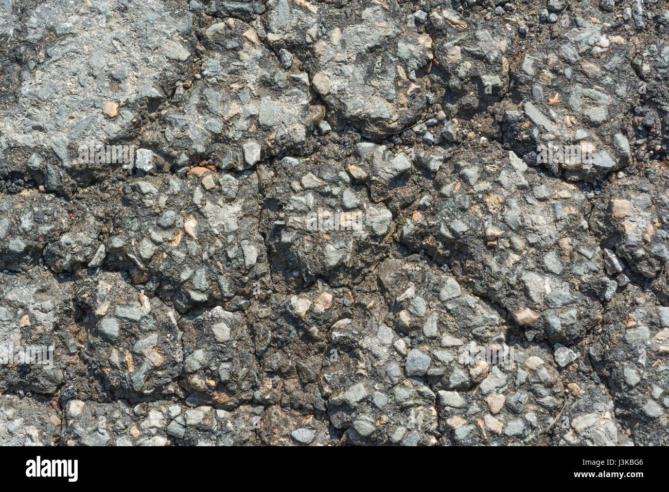 Broken alligator cracked tarmac road surface. For falling apart ...