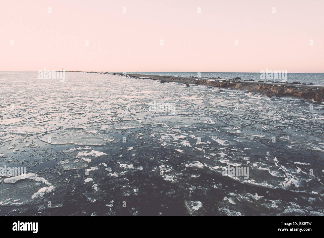 sunset over frozen sea with ice blocks and dramatic colorful sky ...
