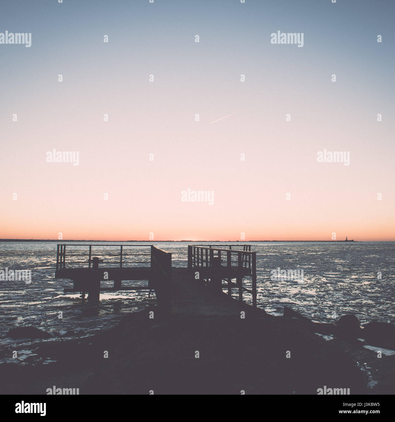 sunset over frozen sea with ice blocks and dramatic colorful sky with ...