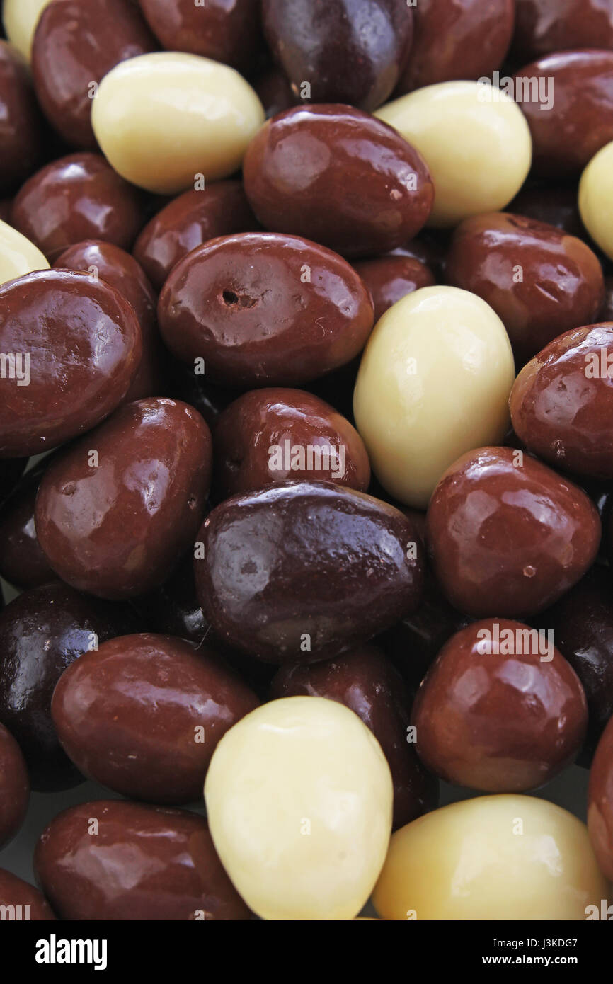 Dark and dairy chocolate balls. Chocolate drops as background texture ...