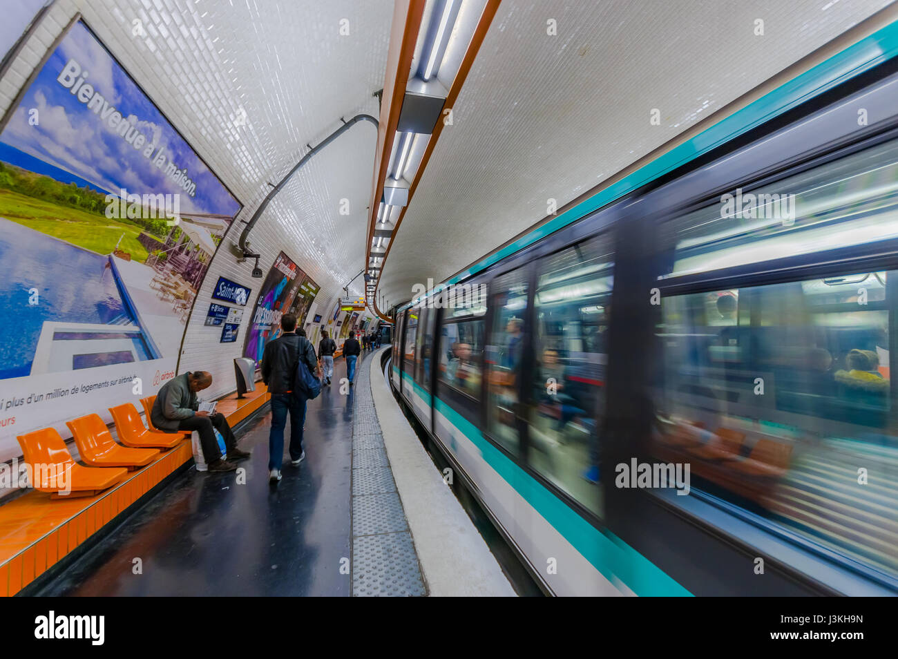 Paris, France June 1, 2015: Train inside Parisian metro station, people ...