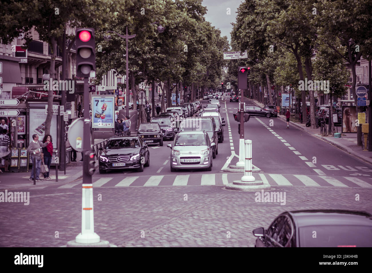 Paris, France June 1, 2015: Typical street with traffic and cars parked ...