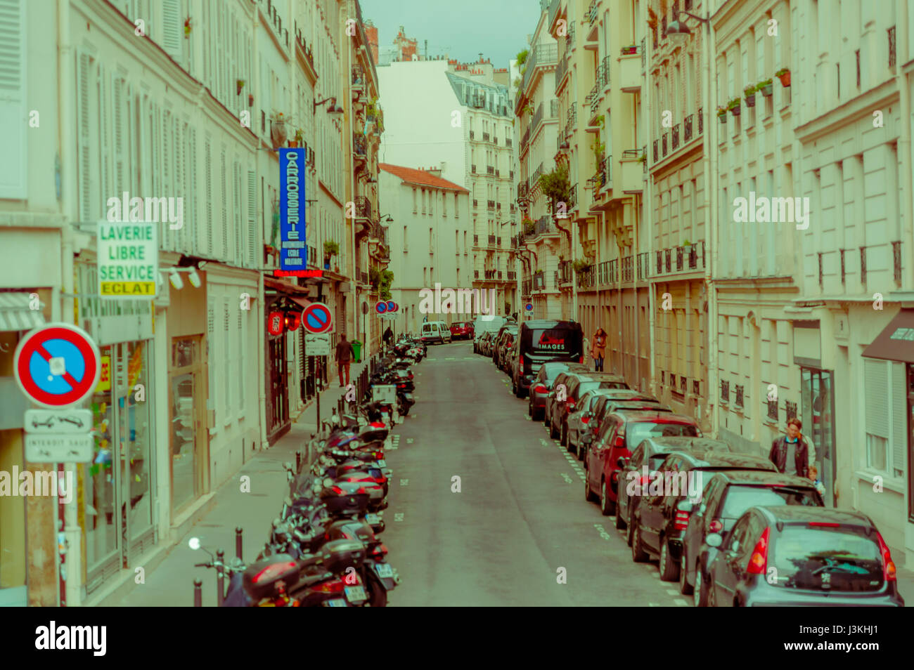Paris, France June 1, 2015: Typical street with traffic and cars parked ...