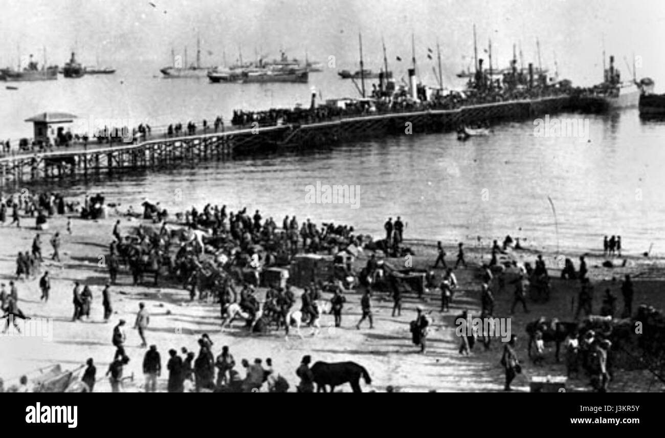 The image depicts Greek soldiers unloading ammunition at the port of ...