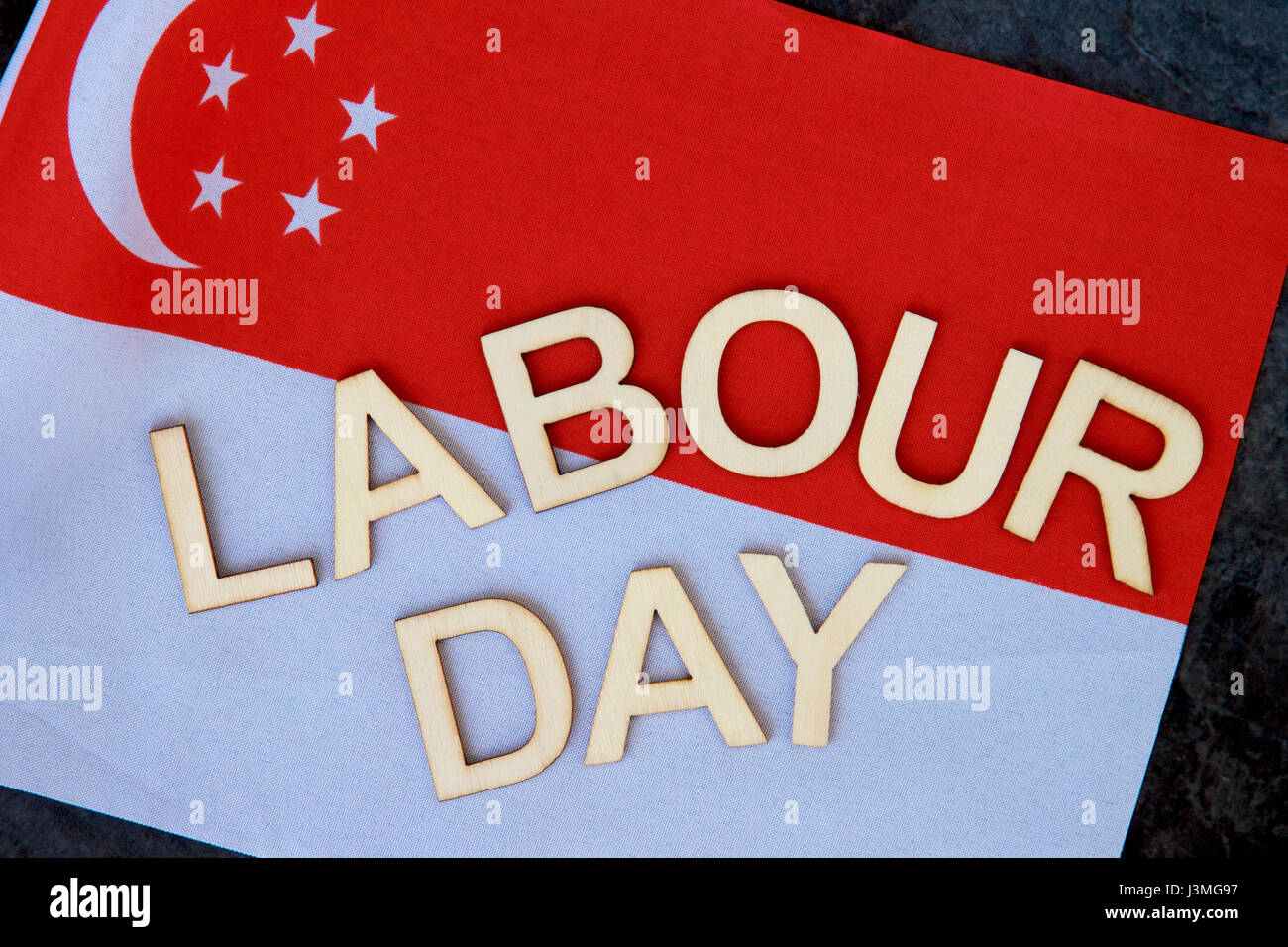 Labour day signage and Singaporean flag Stock Photo - Alamy
