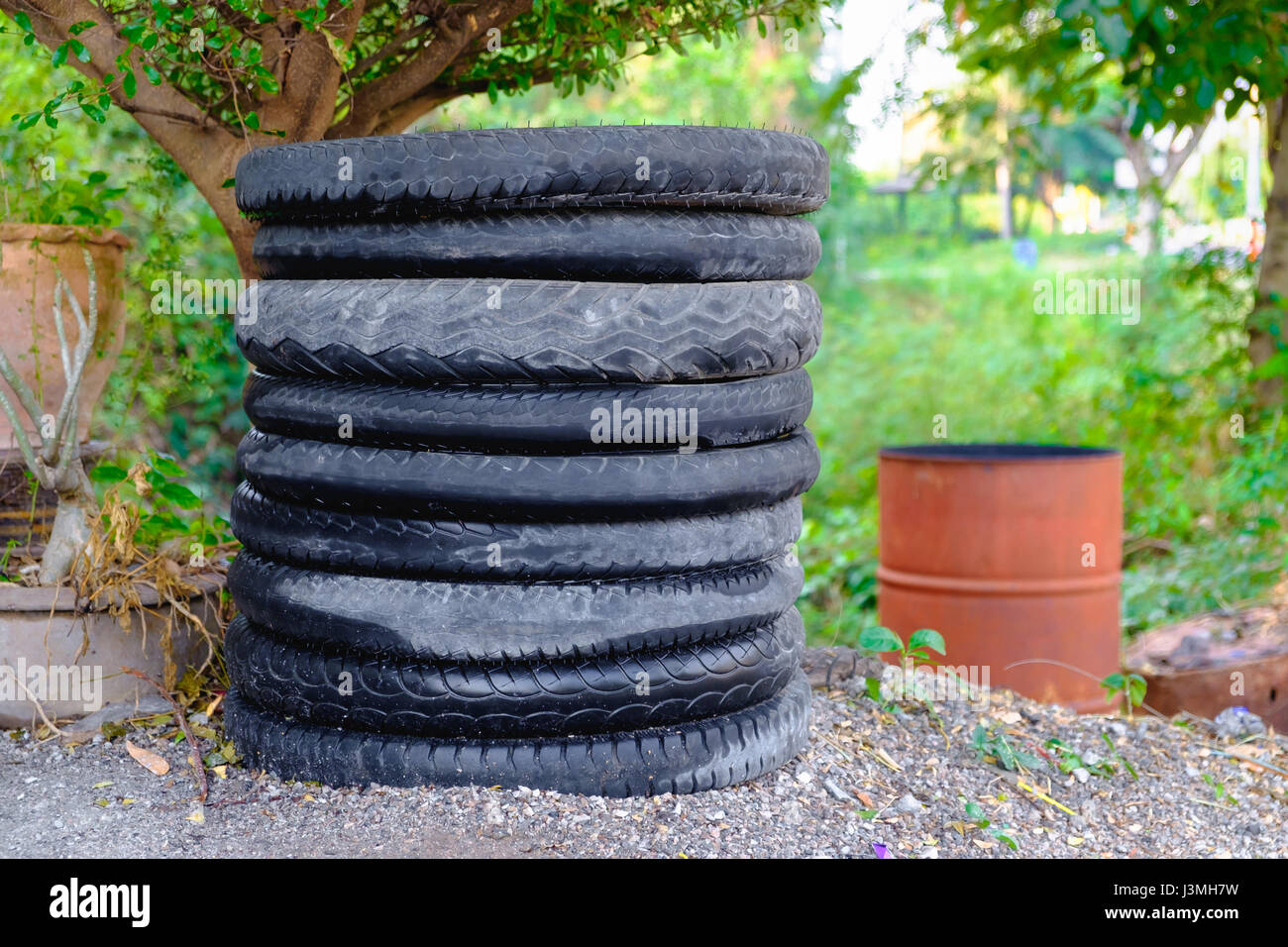 Stack of old motorcycle tires on the ground Stock Photo - Alamy