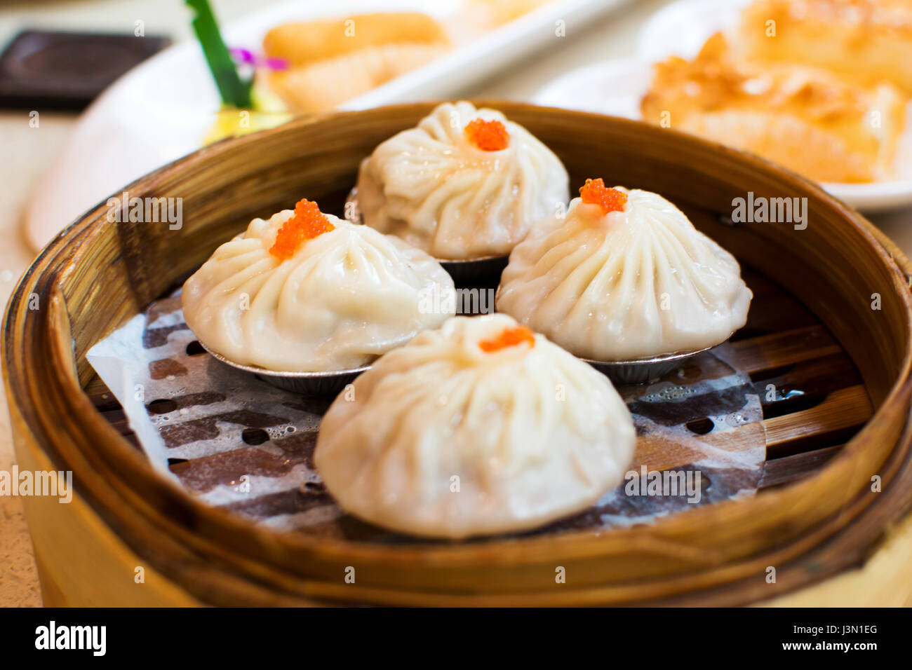Steamed pork baozi in soup on bamboo steamer Stock Photo - Alamy