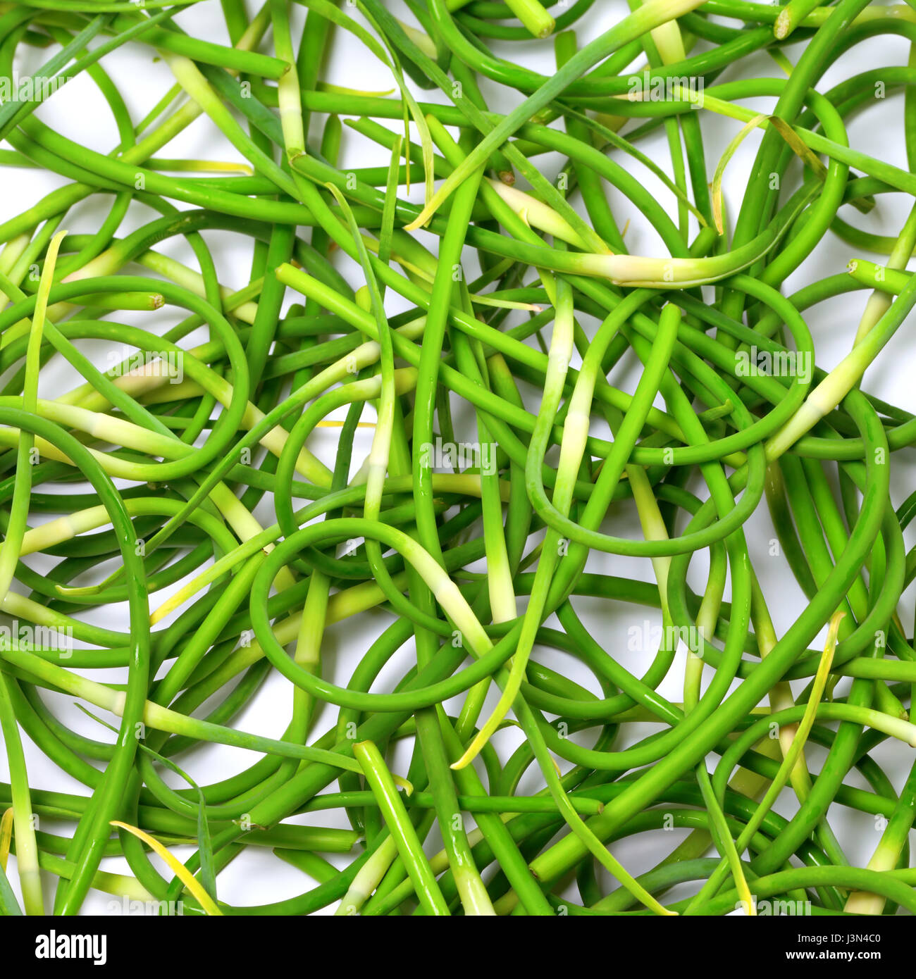 Background of fresh garlic scape Stock Photo - Alamy