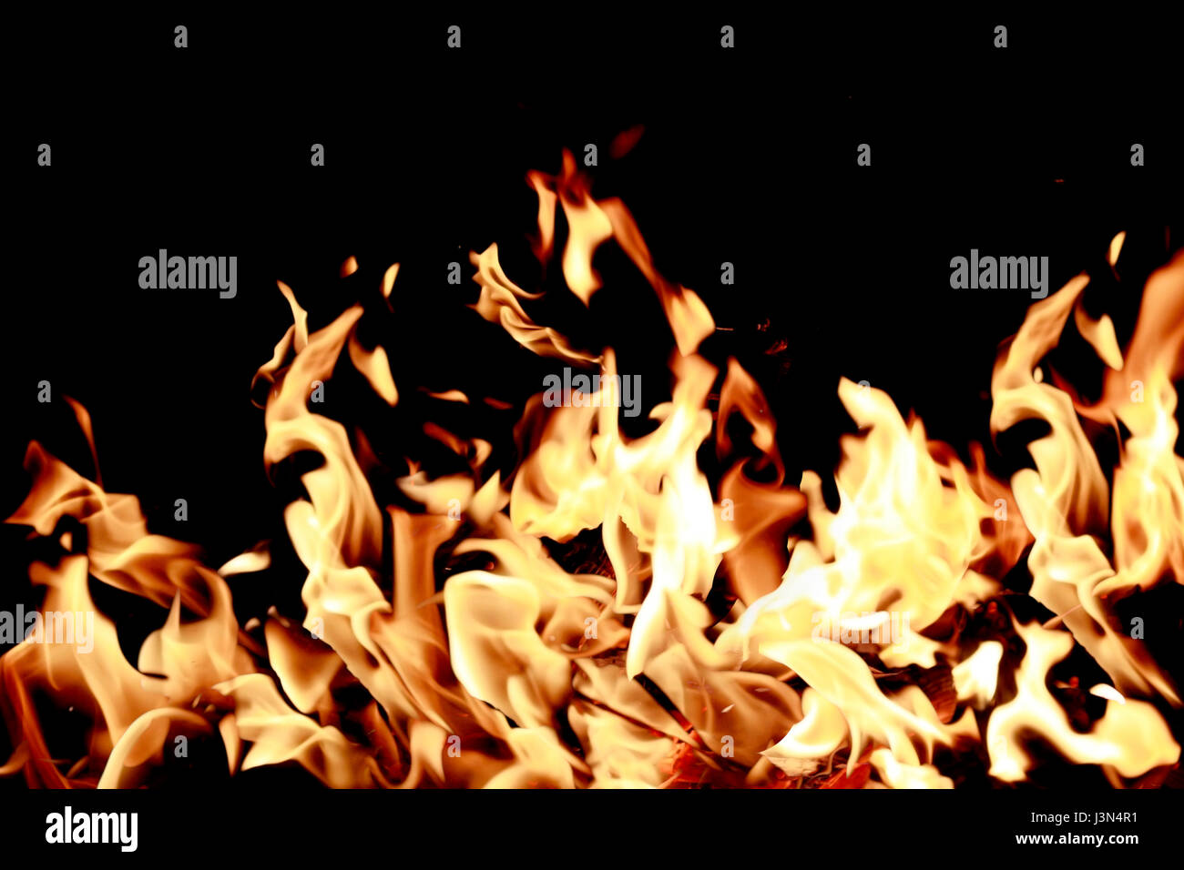 Intense fire isolated over black background Stock Photo - Alamy