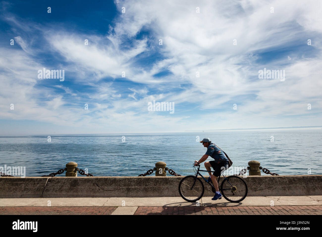 Cyclist riding along the waterfront in Burlington Ontario Stock Photo ...