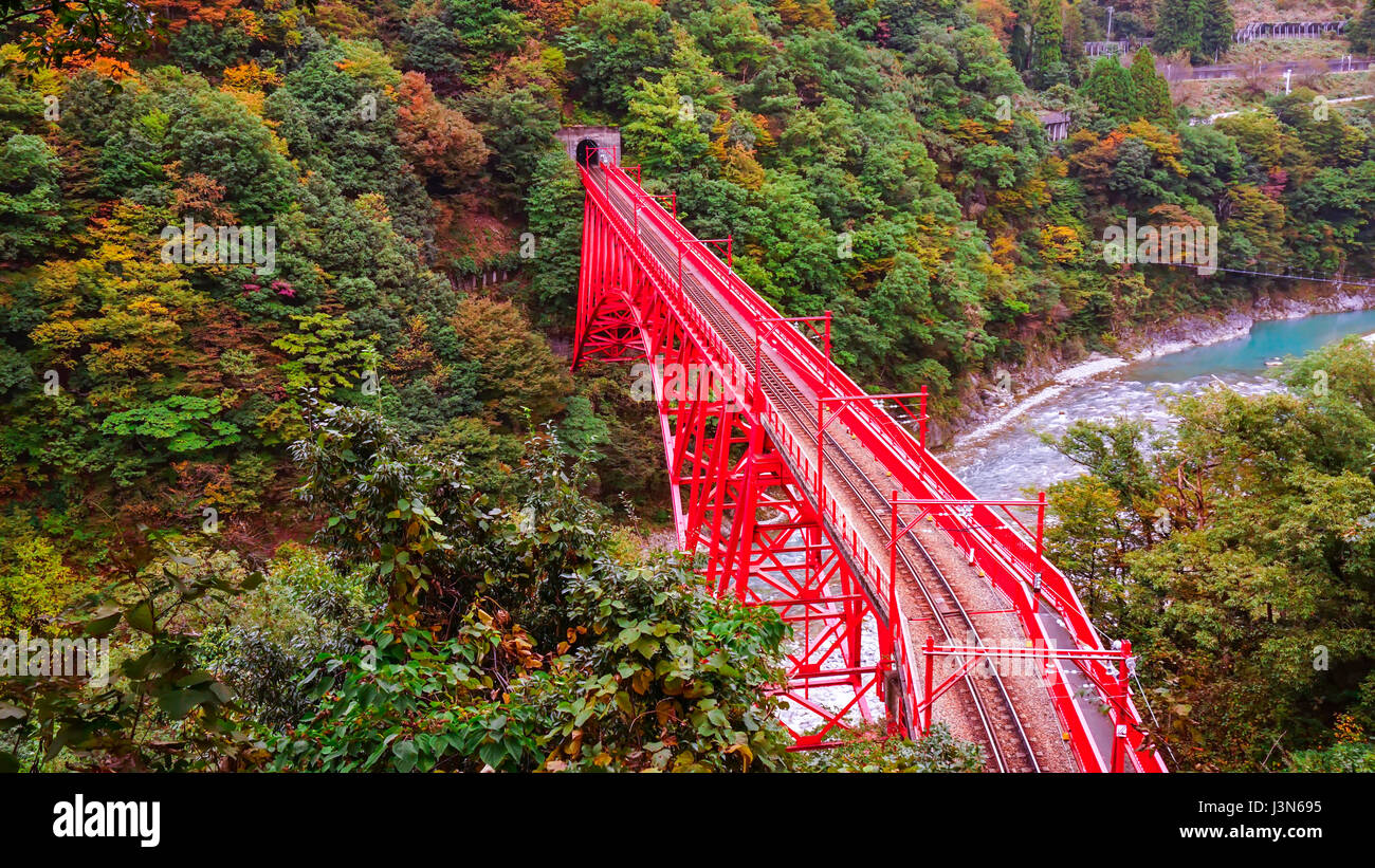 Shin Yamabiko red bridge cross the river at Unazuki station in Kurobe ...