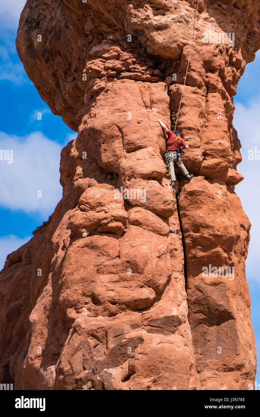 Rock climber on pinnacle in Arches national Park, Utah Stock Photo - Alamy