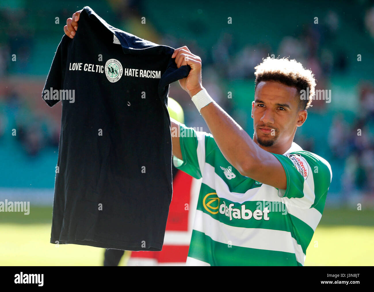 Celtic's Scott Sinclair holds up shirt given to him by fans at the end ...