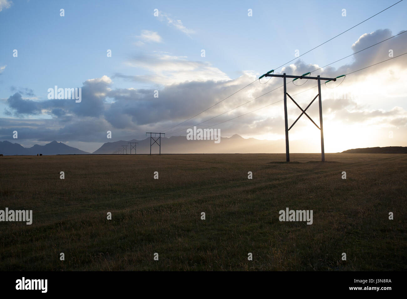 Power pole with sunset in Iceland. Light and shadow over the landscape ...