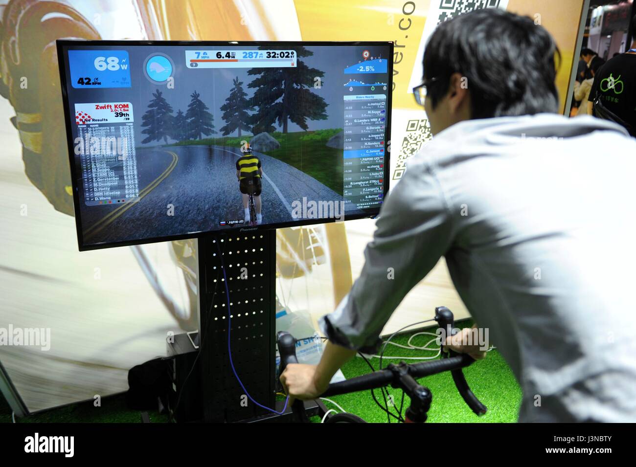 Shanghai, China. 6th May, 2017. A visitor experiences a bicycle video ...
