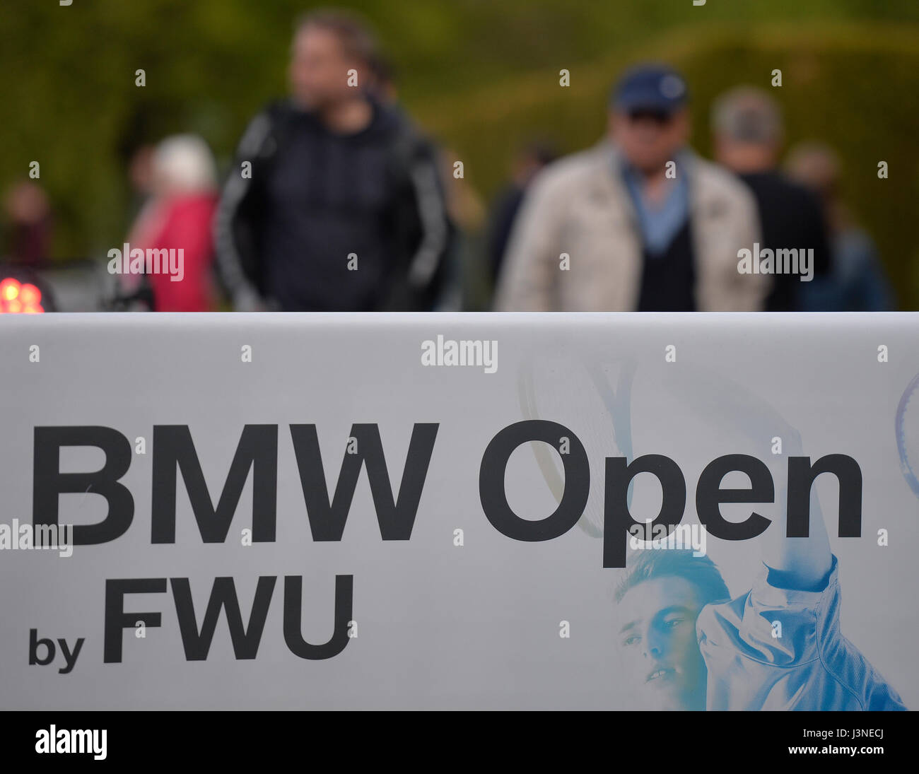 Munich, Germany. 05th May, 2017. Spectators pass by a BMW Open logo ...