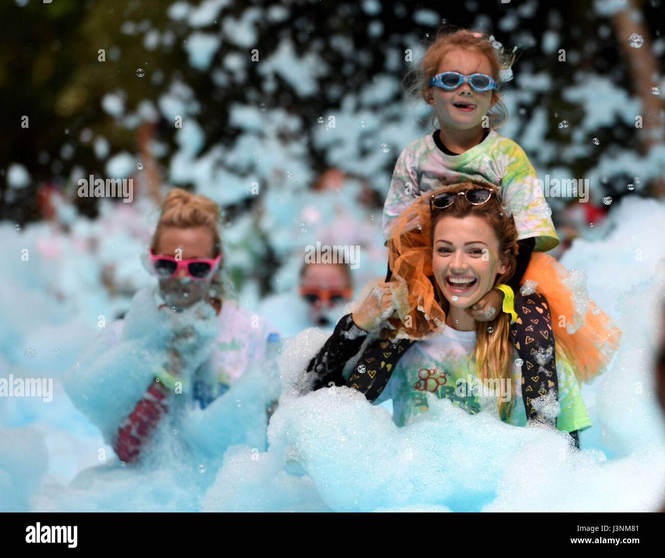Participants enjoy the race around a course of bubbles in Dorset's ...