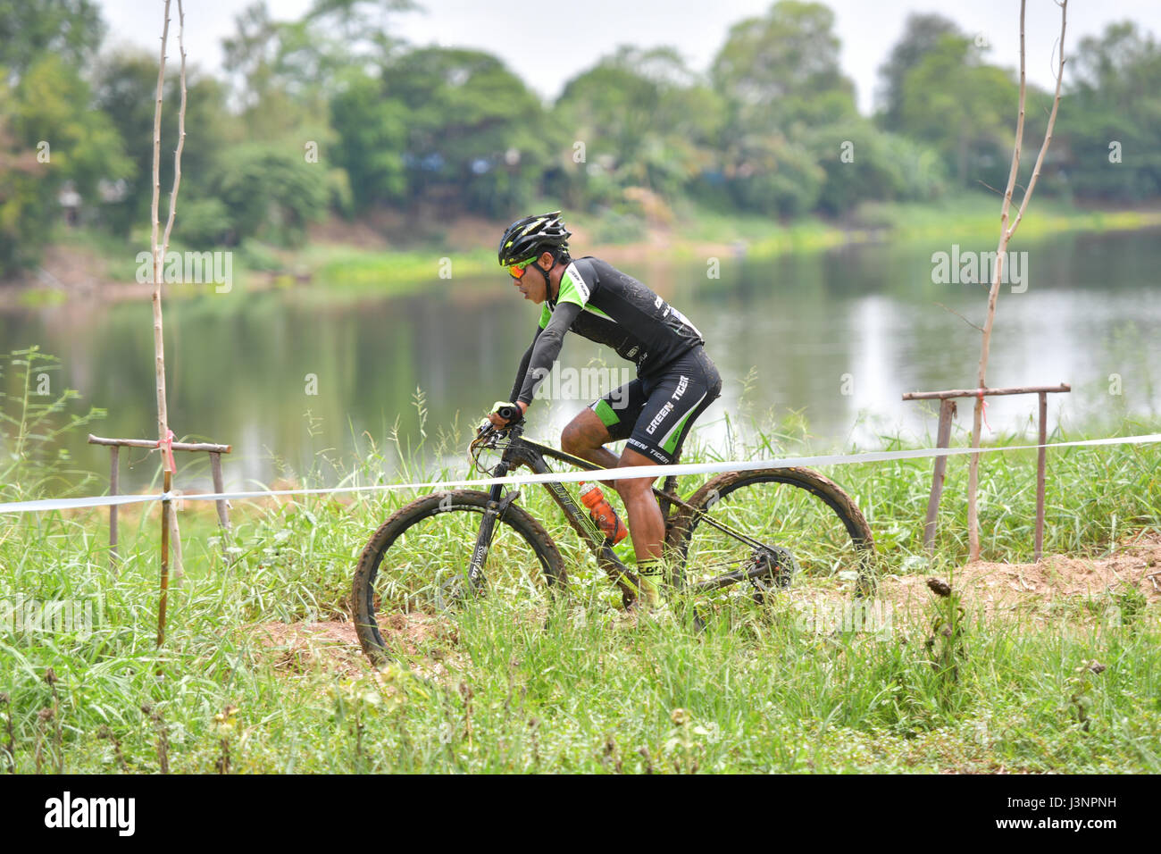 Singburi, Thailand. 7th May 2017. Biker riding a mountain bike at ...