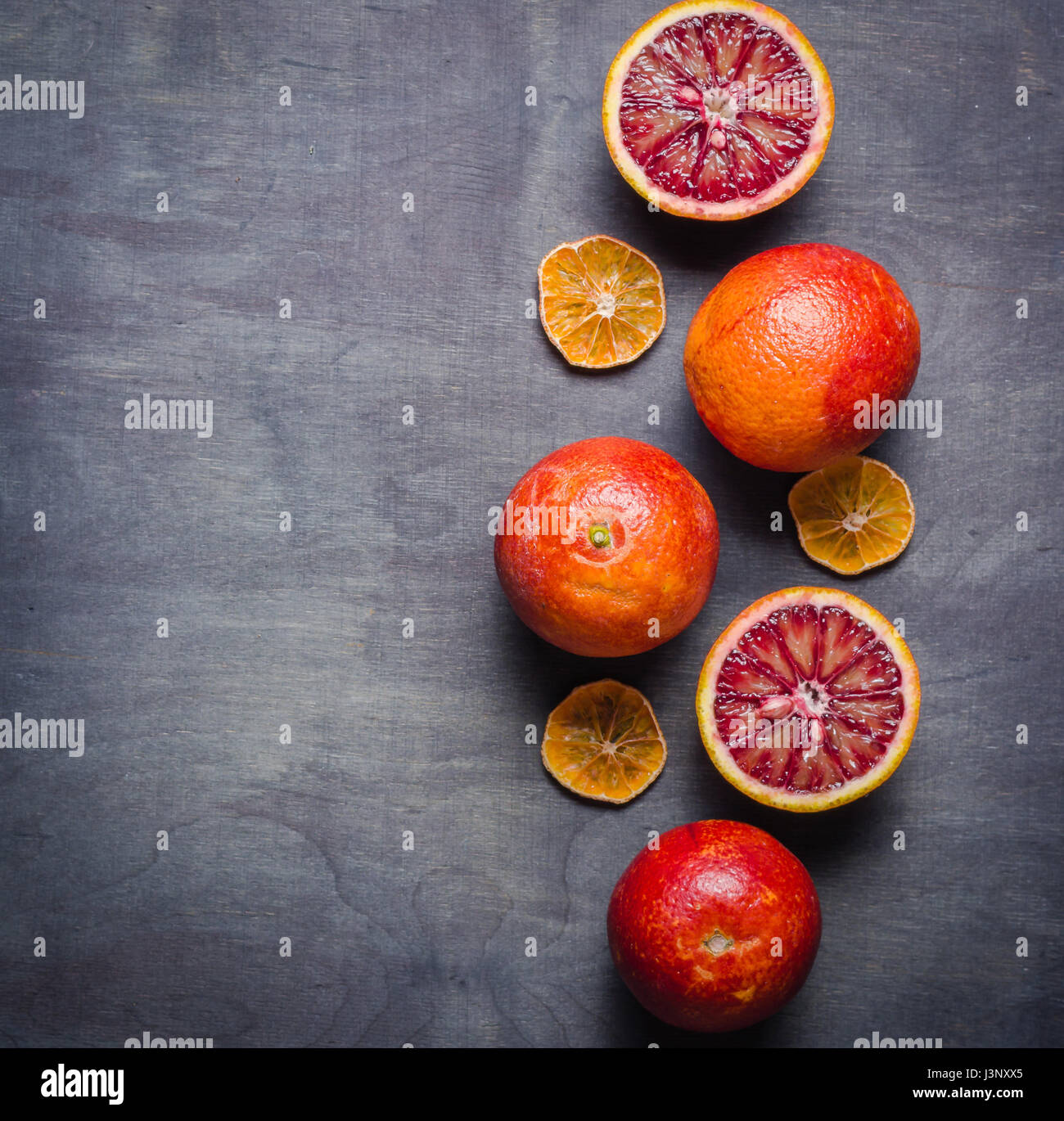 Several oranges of orange and red on a black background. View from ...