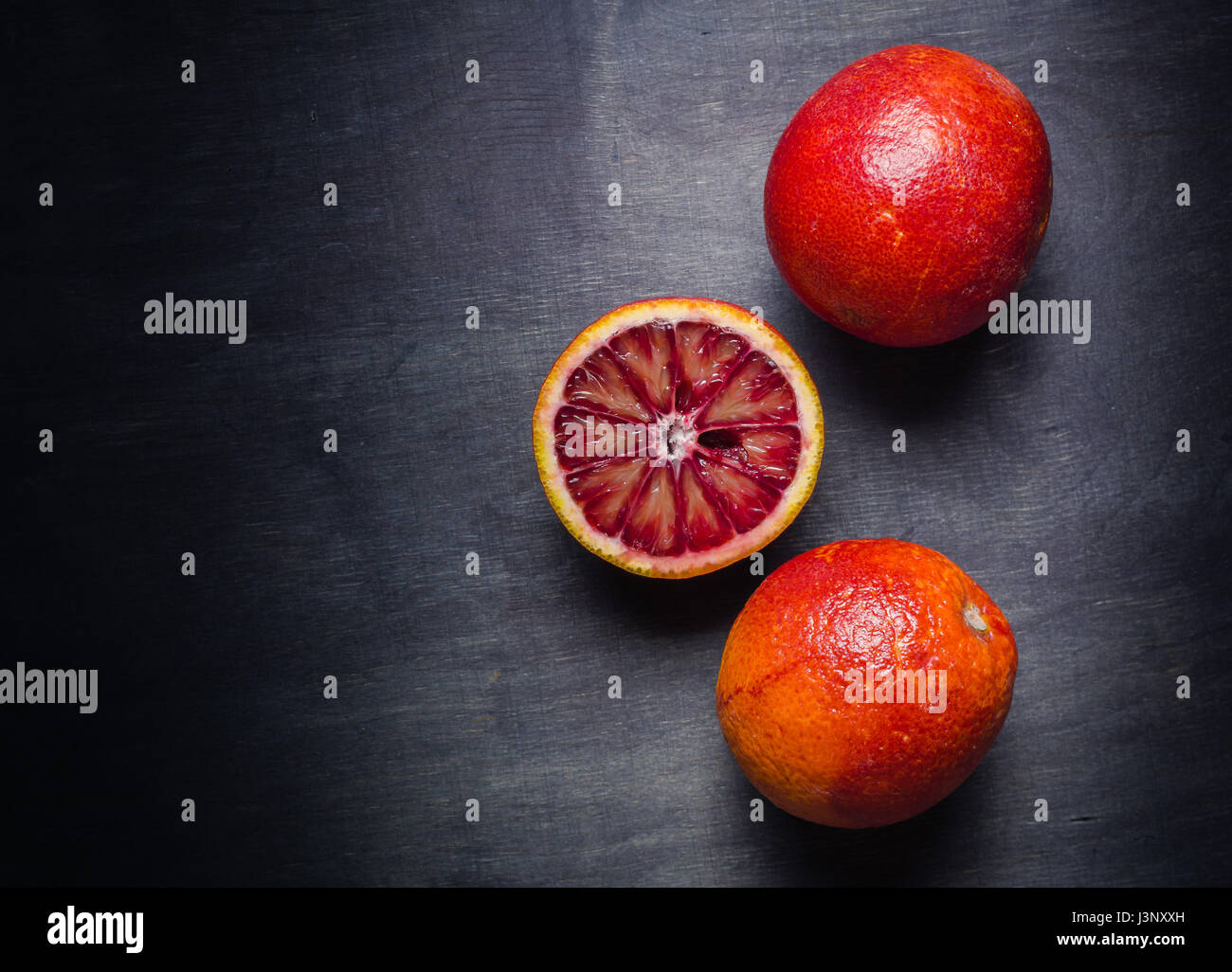 Several oranges of orange and red on a black background. View from ...